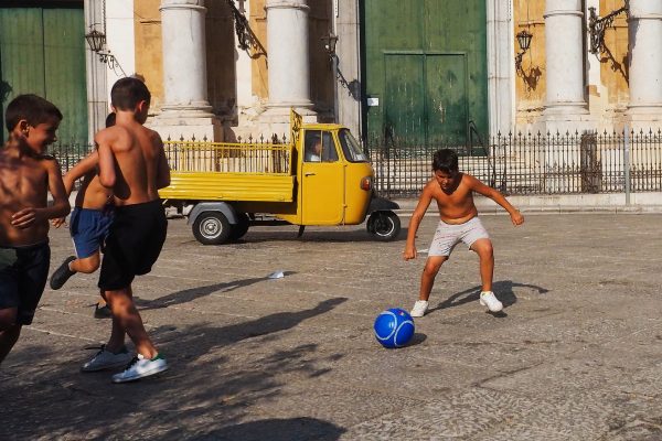 Children playing soccer on the street 2 - Exibart Street