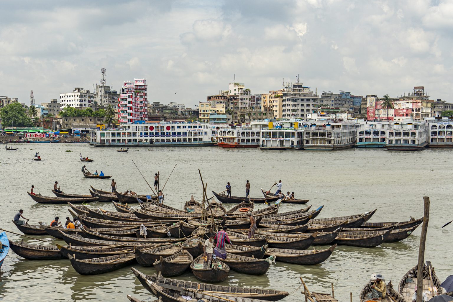 Aerial view of traditional boats docked at Old Dhaka river port along Buriganga shoreline river ...
